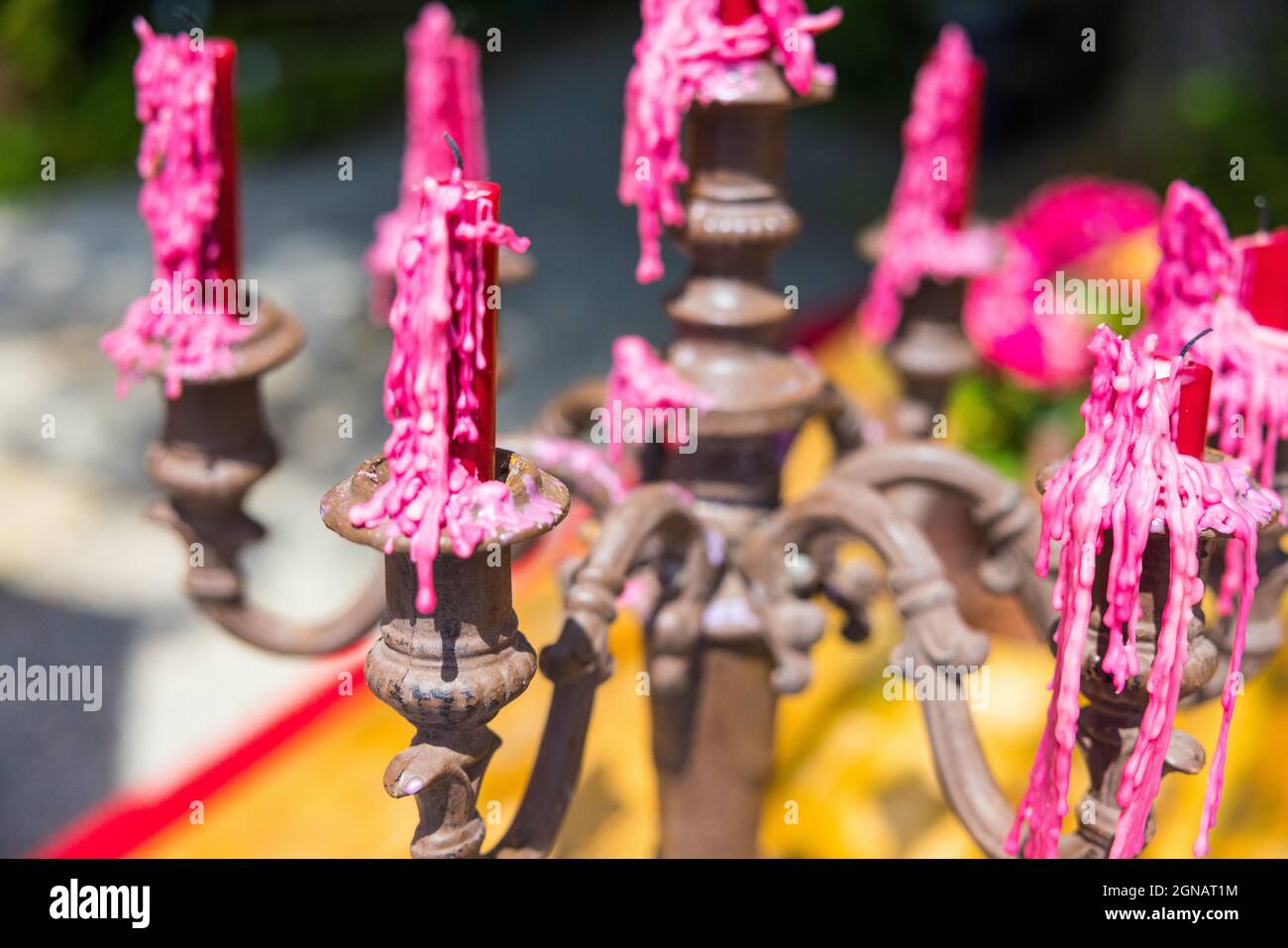 Melted candlesticks on a vintage candle holder Stock Photo - Alamy