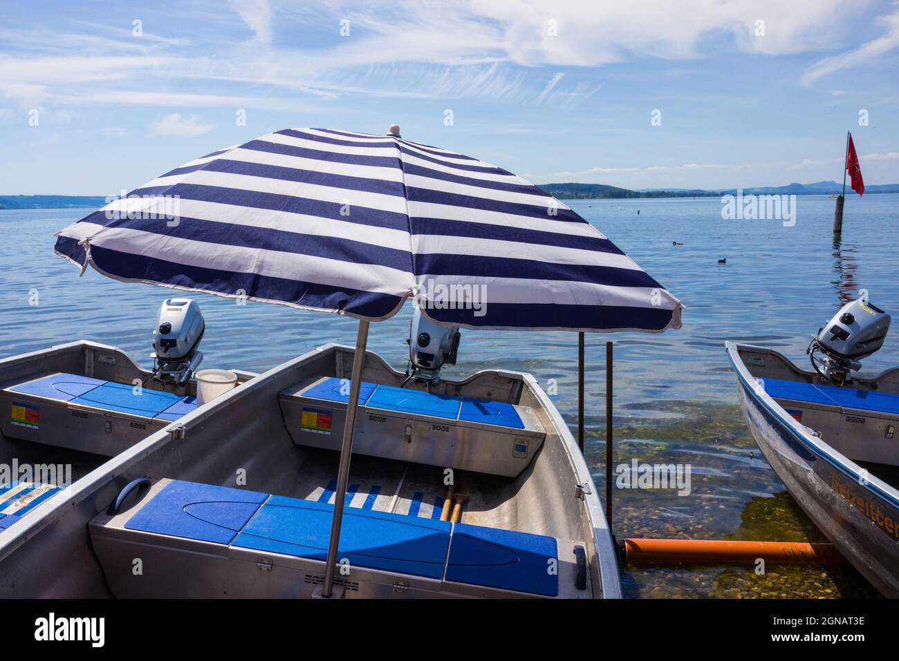 KONSTANZ, GERMANY - Aug 30, 2021: A boat with an umbrella on it on Lake Constance, Germany Stock ...