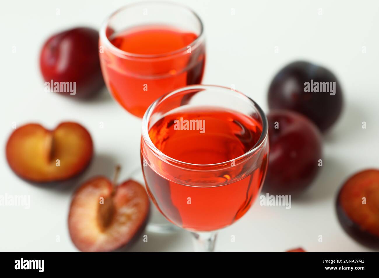 Plum brandy shots and ingredients on white background Stock Photo - Alamy