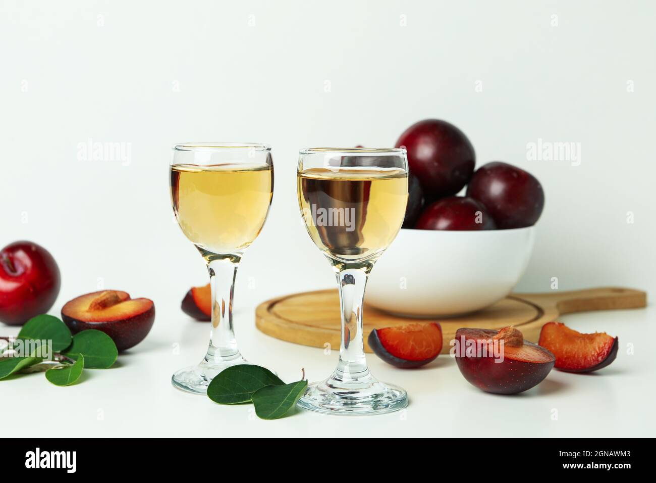 Plum vodka shots and ingredients on white background Stock Photo - Alamy