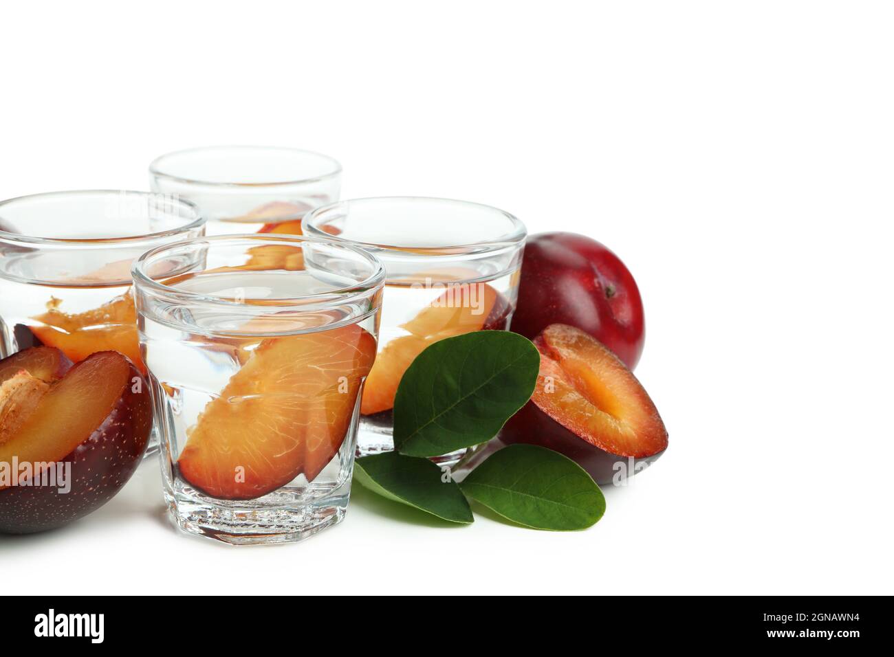 Plum vodka shots isolated on white background Stock Photo - Alamy