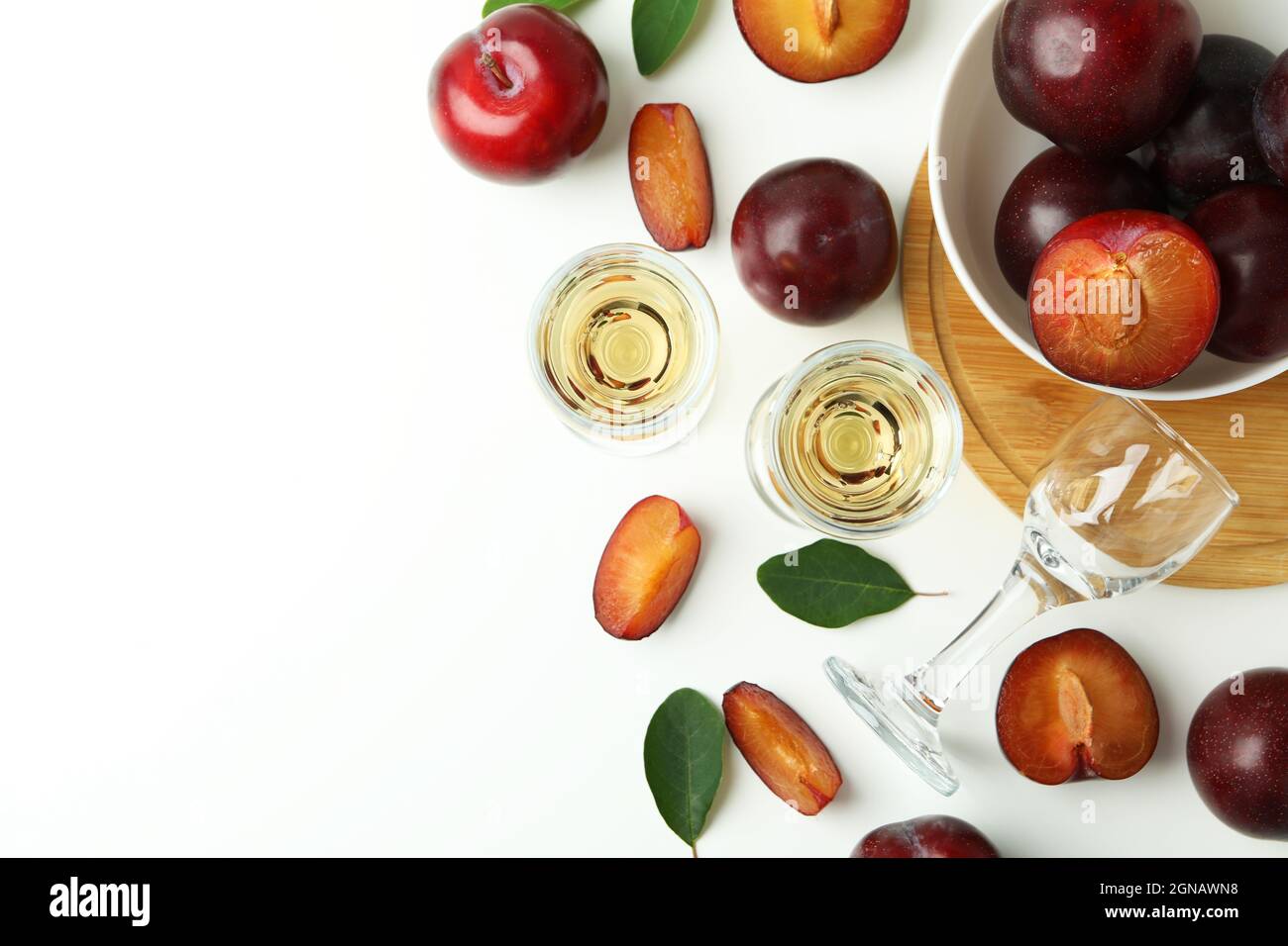 Plum vodka shots and ingredients on white background Stock Photo - Alamy