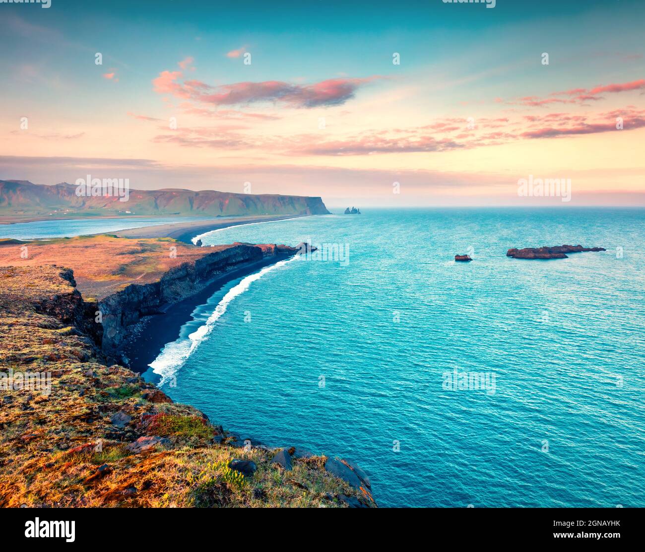 Colorful summer sunset on the Kirkjufjara beach. Evening view of ...