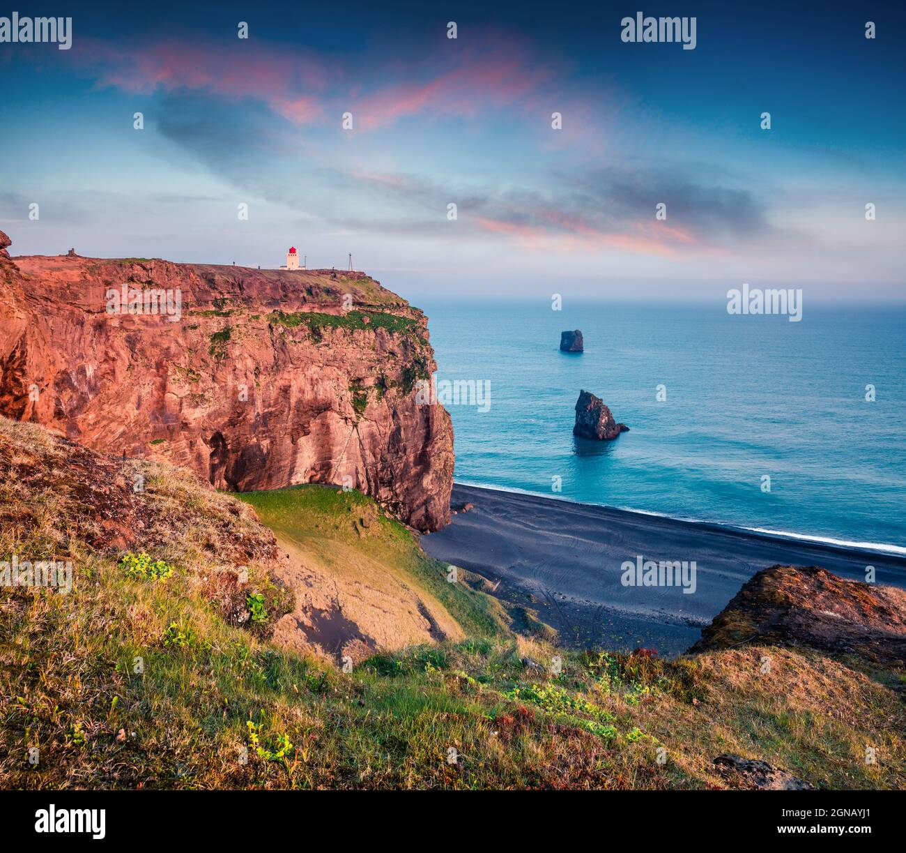 Dramatic summer sunset in Dyrholaey Nature Reserve. Lighthouse from ...