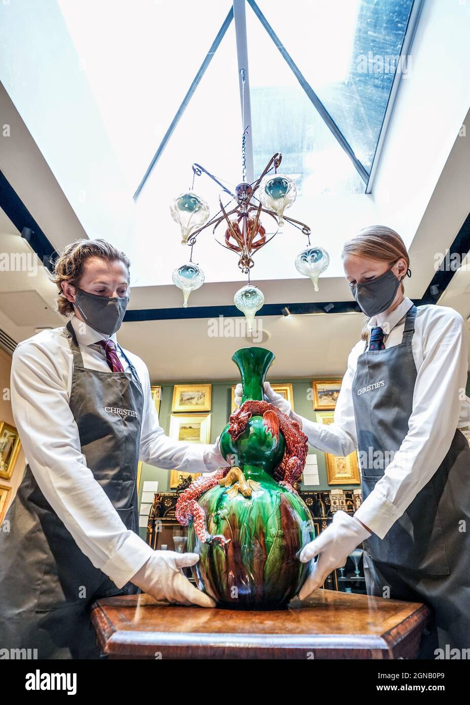 Christie's employees adjust a Burmantofts Faience Green-Glazed Double ...