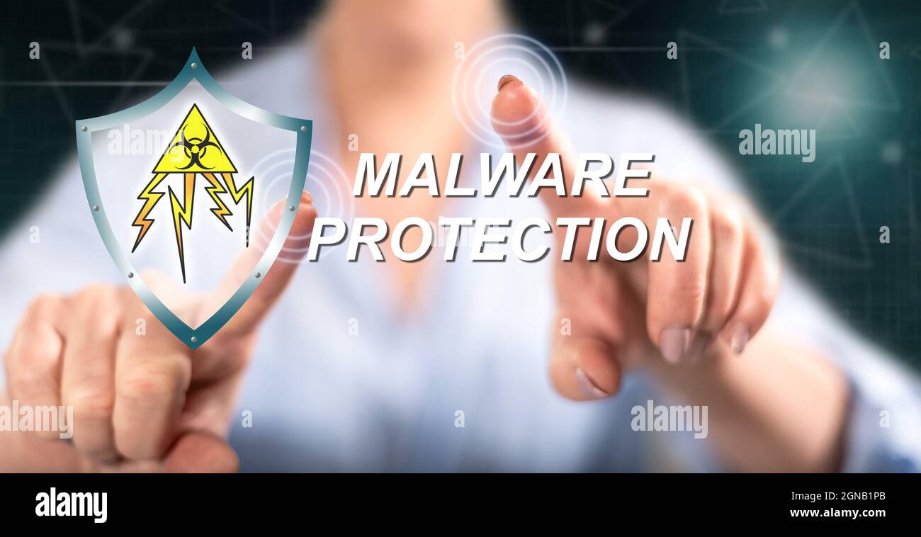 Woman touching a malware protection concept on a touch screen with her ...