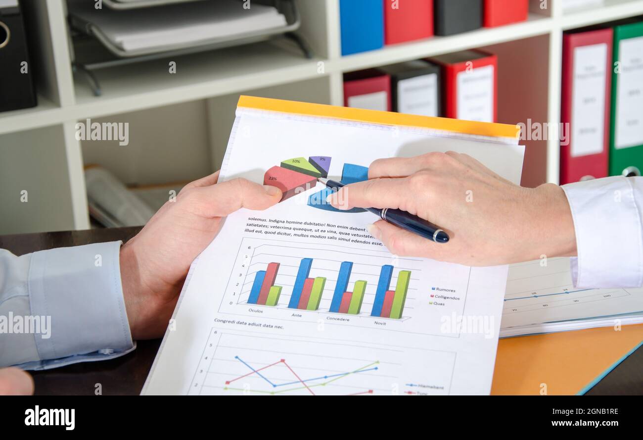 Two business people analyzing a chart Stock Photo - Alamy
