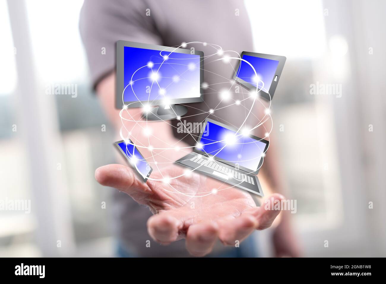 Devices connection concept above the hand of a man in background Stock ...