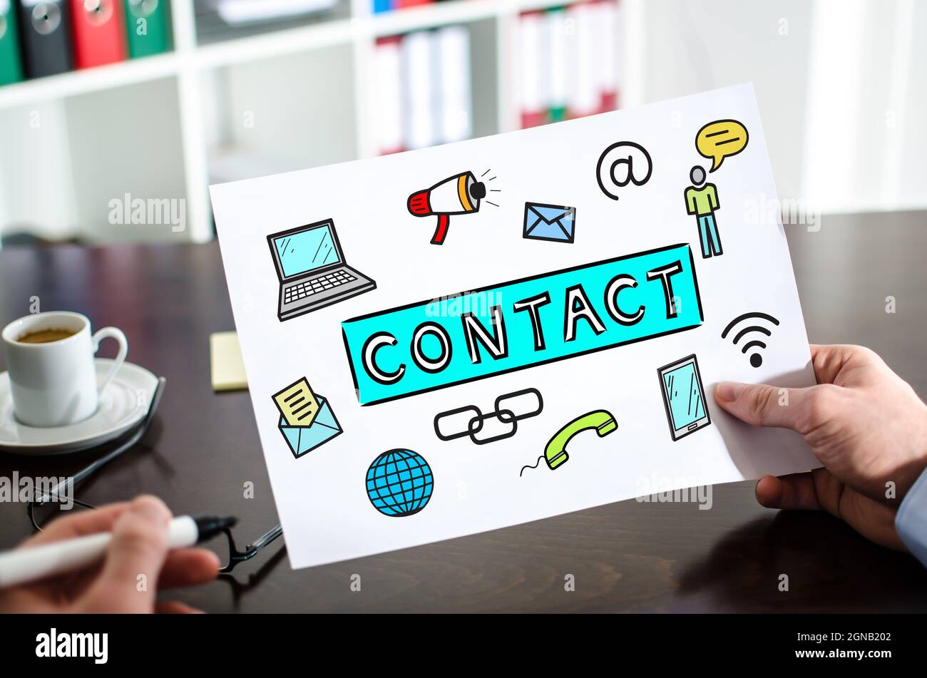 Hand holding a paper showing contact concept Stock Photo - Alamy
