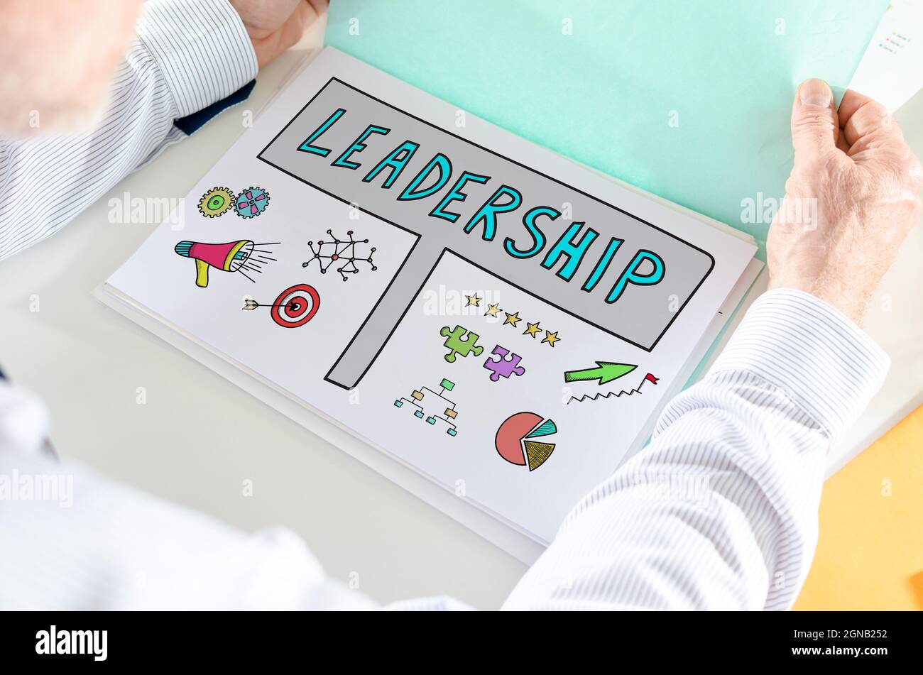 Man holding a file with leadership concept Stock Photo - Alamy