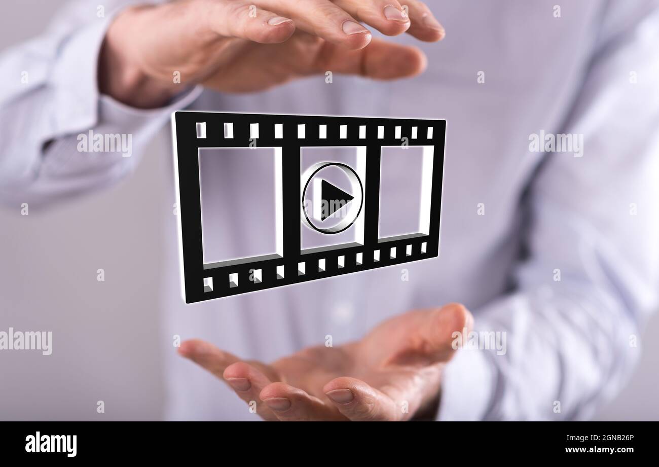 Movies, video and cinema concept between hands of a man in background ...