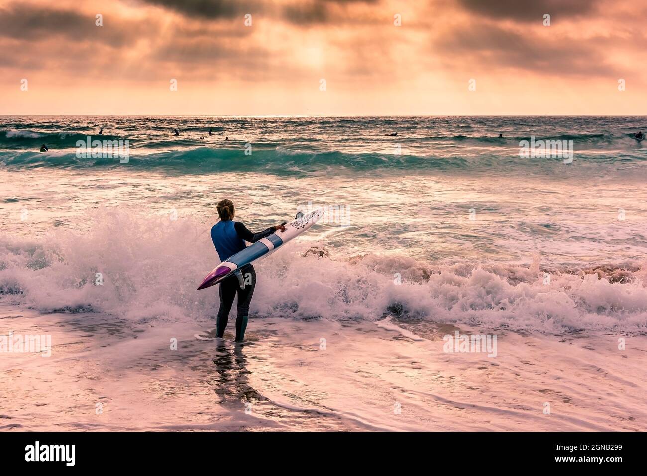 Late evening light over a member of Newquay Surf Lifesaving Club at a ...