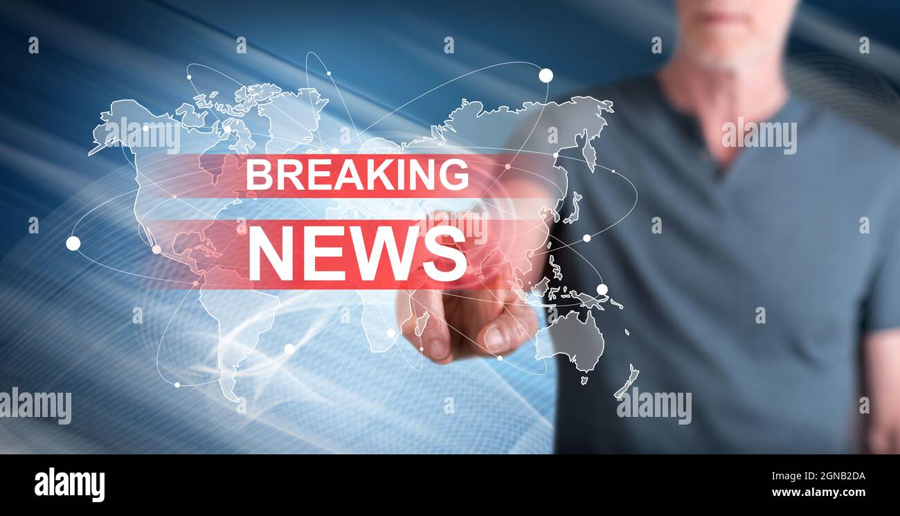 Man touching a breaking news concept on a touch screen with his finger ...