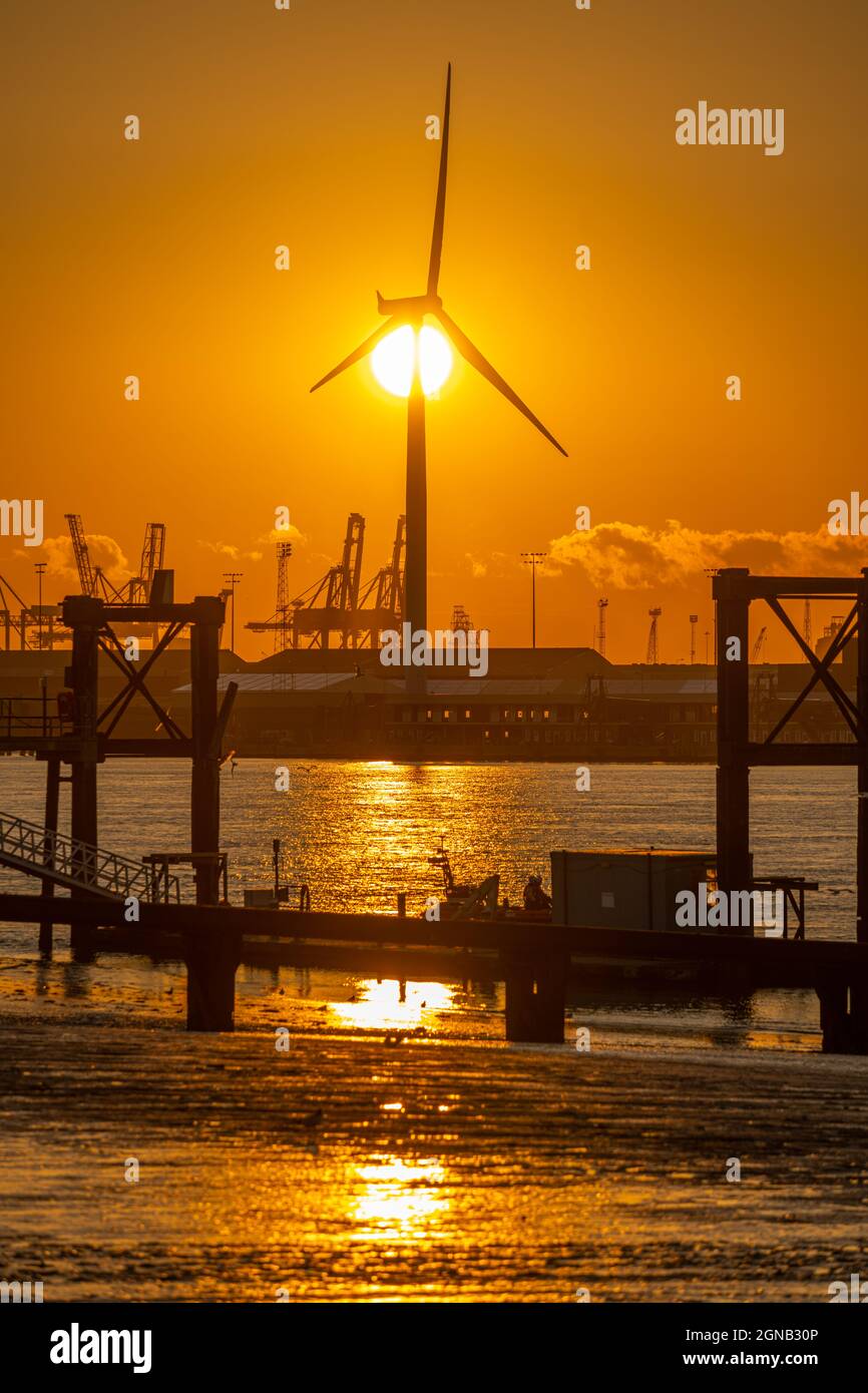 Cranes and wind turbines in Tilbury docks from the promenade at ...