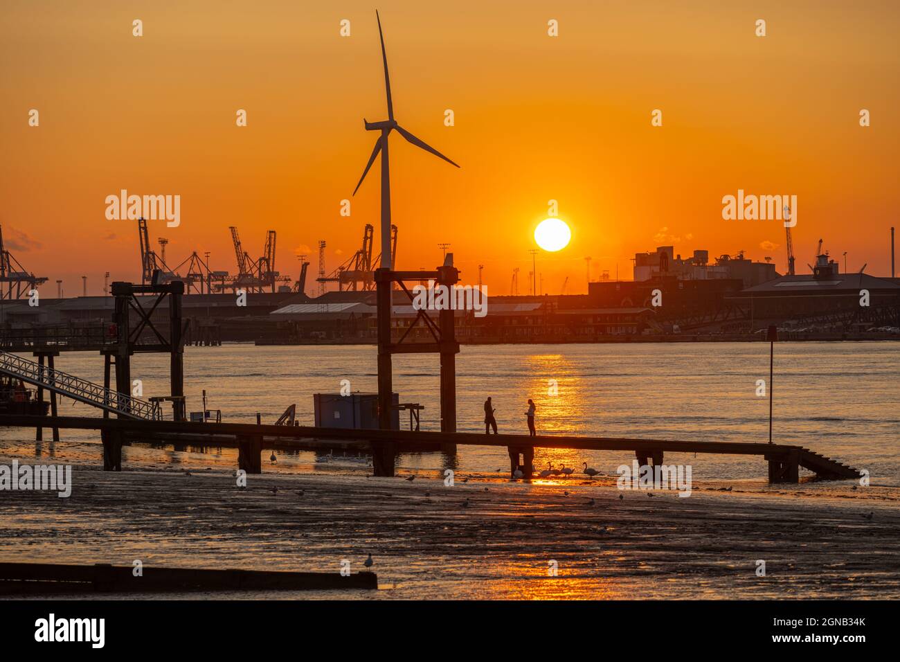 Cranes and wind turbines in Tilbury docks from the promenade at ...