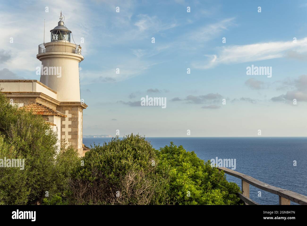 Cap Blanc lighthouse on the rocky coast of the island of Mallorca. In ...