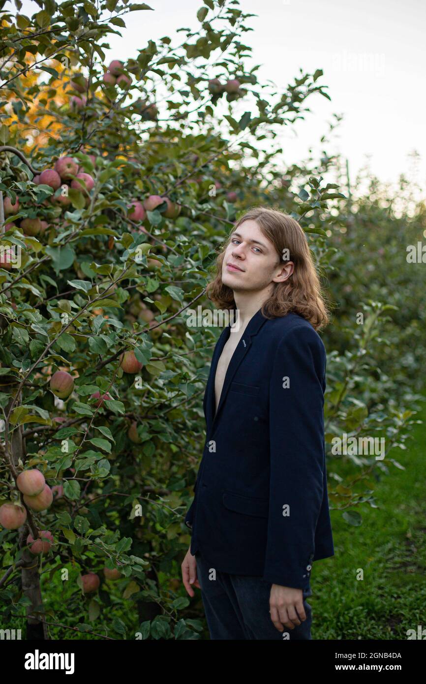Young european white man with long hair near the tree with apples Stock ...