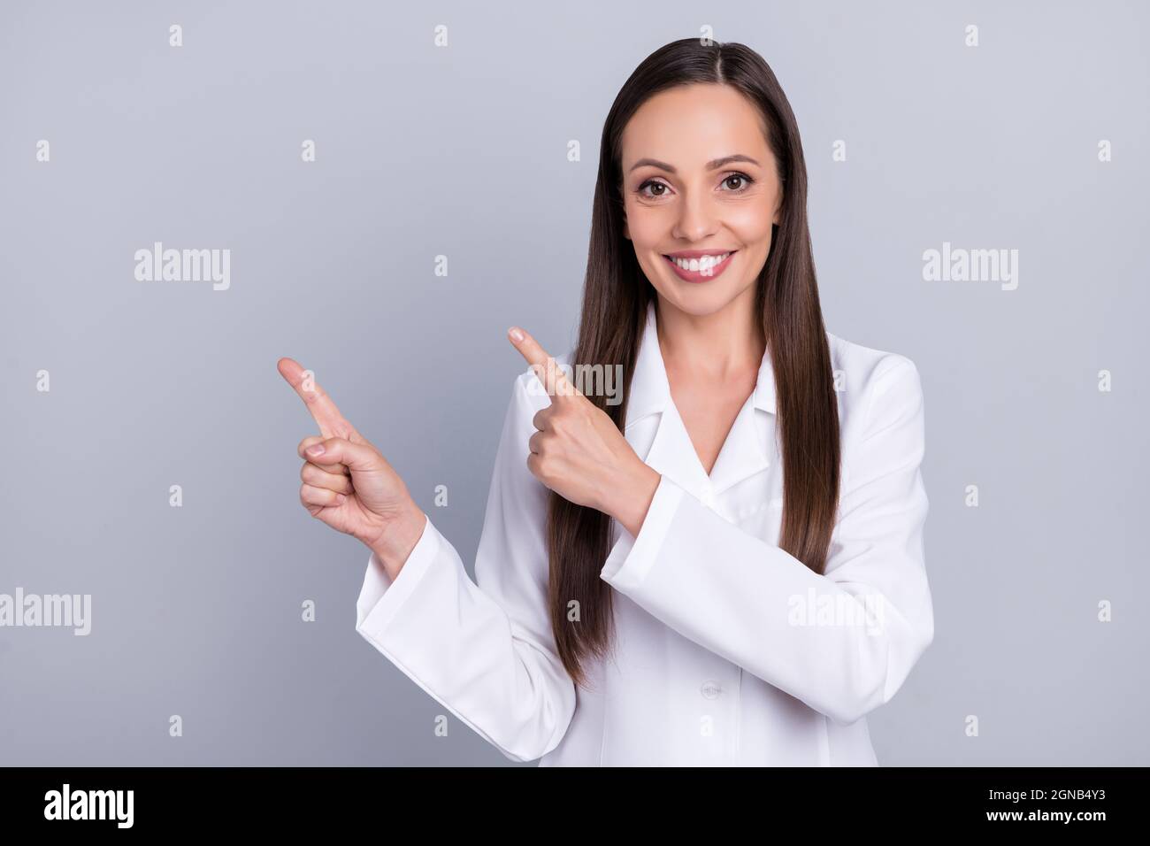 Photo of charming pretty woman doc dressed white coat pointing fingers ...
