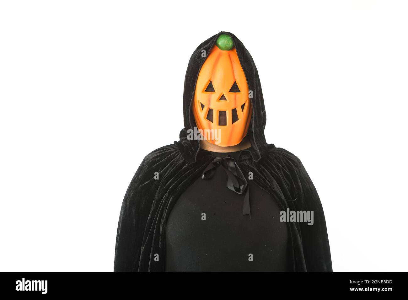 Person wearing pumpkin Jack-o.-lantern mask and hooded velvet cape, on ...
