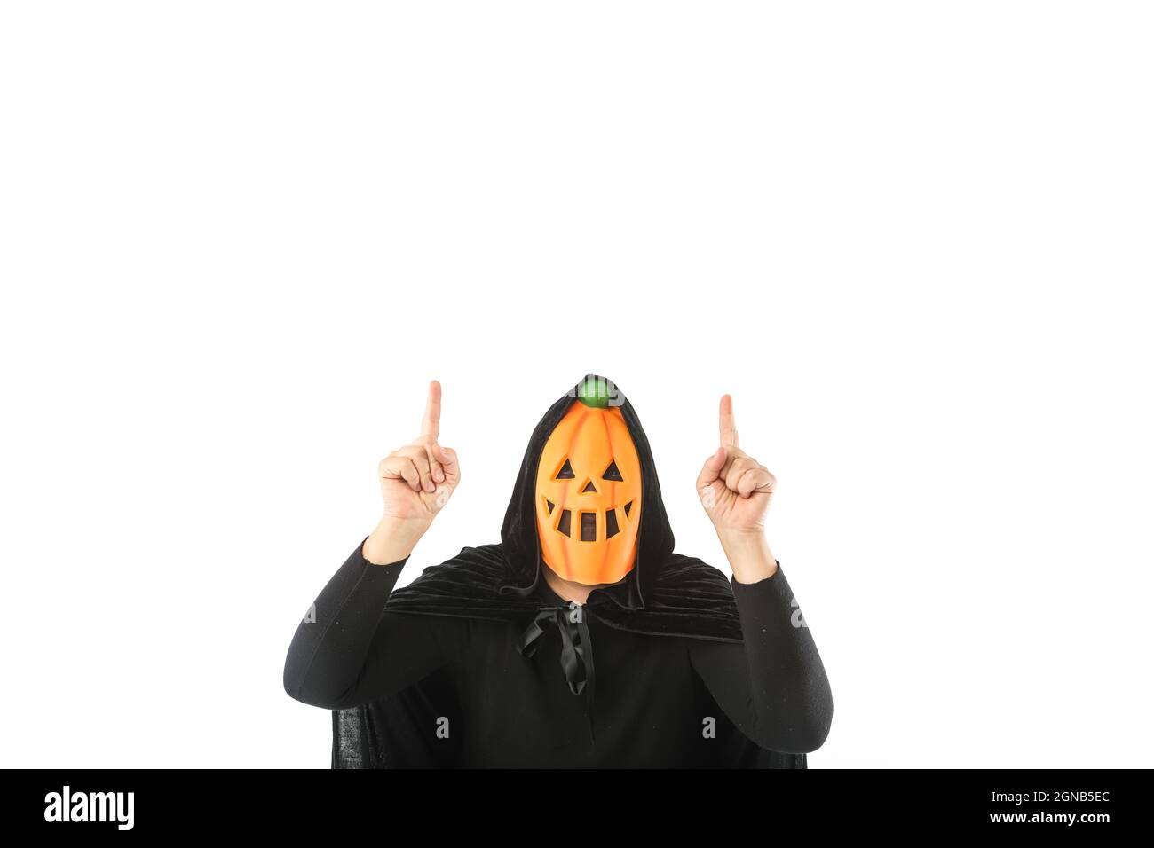 Person dressed in pumpkin Jack-o.-lantern mask and hooded velvet cape ...