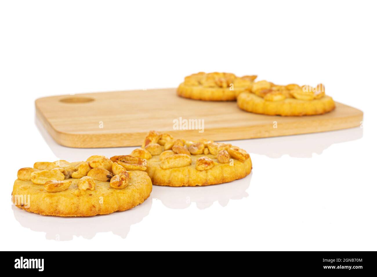 Group of four whole delicious cookie with peanuts on bamboo cutting ...