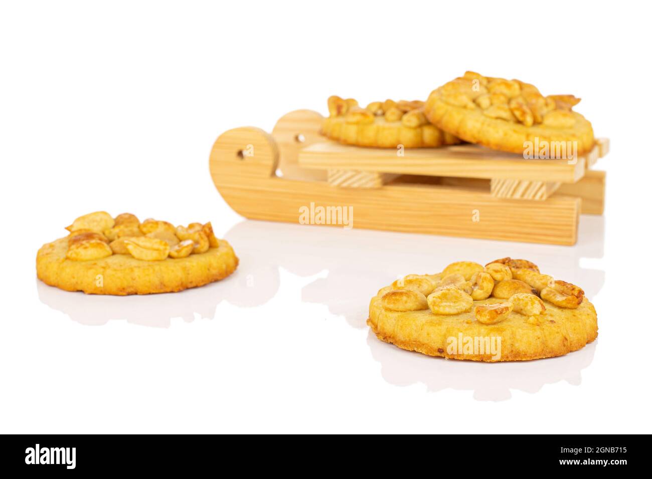 Group of four whole delicious cookie with peanuts with wooden sledge on ...