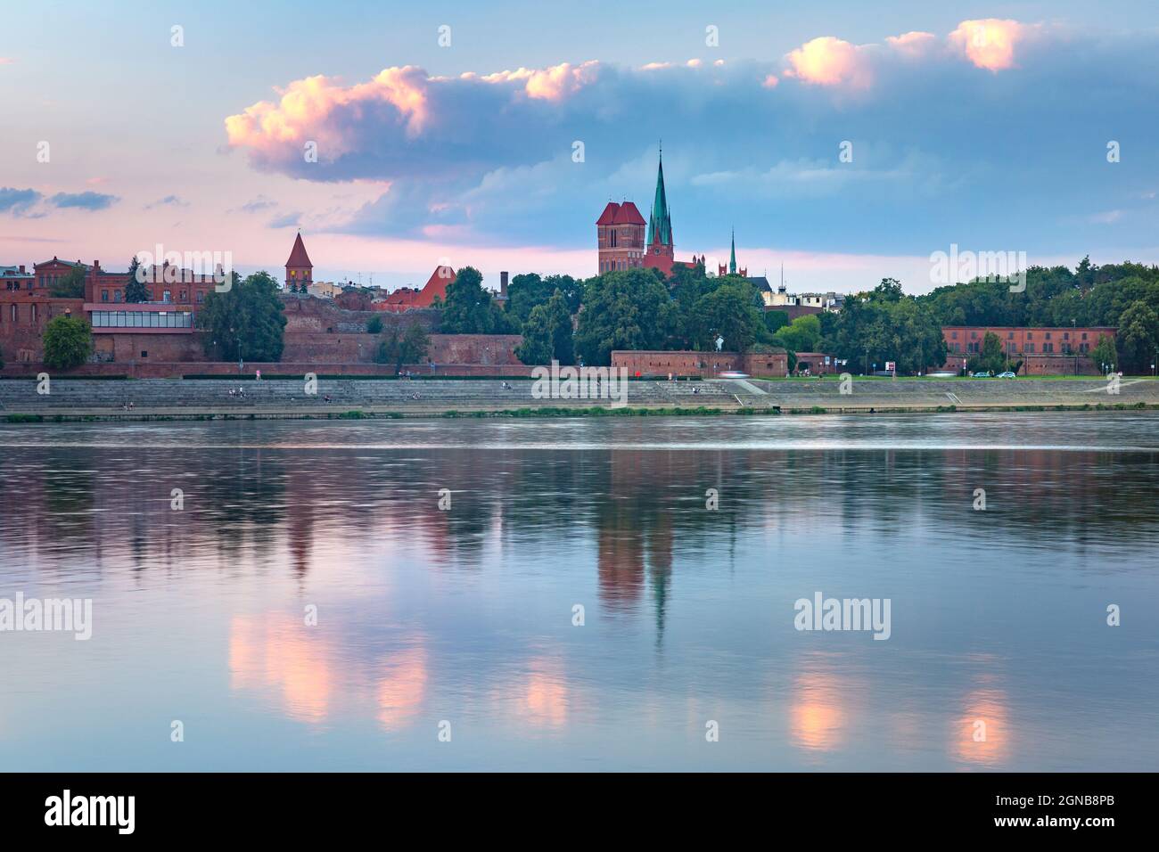Panorama of Old Town of Torun seen from the Vistula at sunset, Poland ...