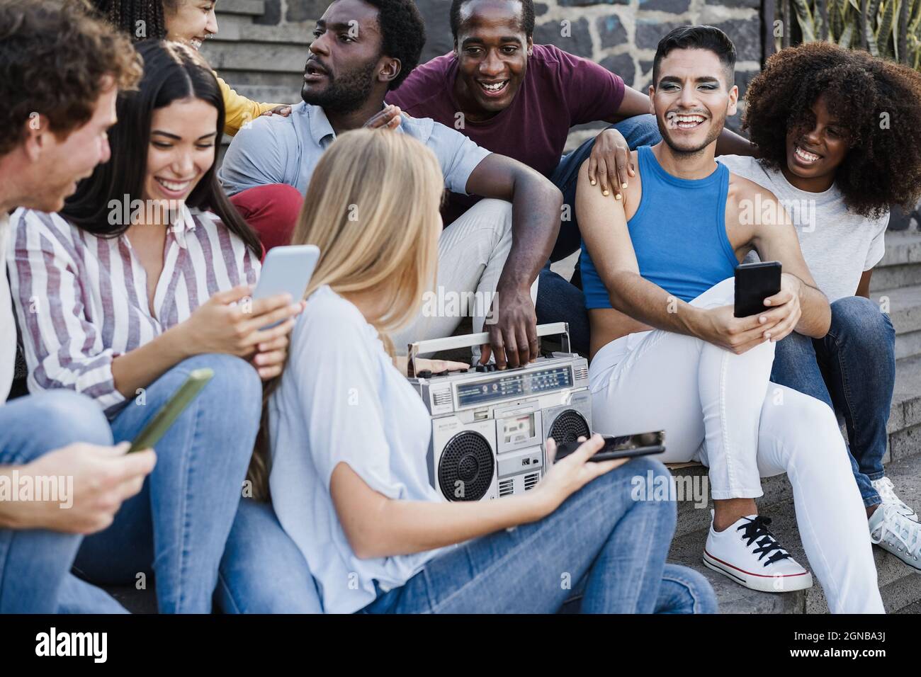 Young diverse people dancing and listening music with boombox stereo ...