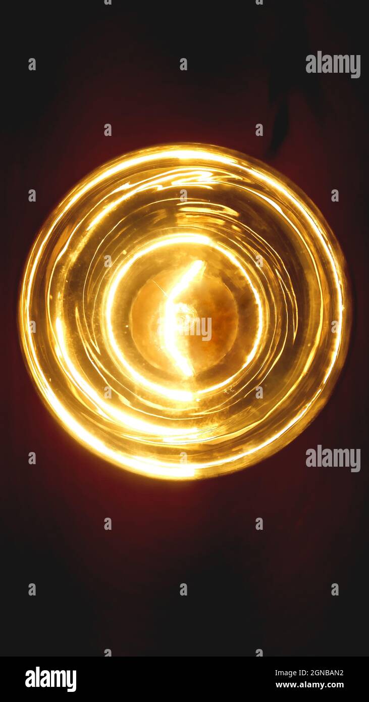 golden light bulb with glowing filament Stock Photo - Alamy