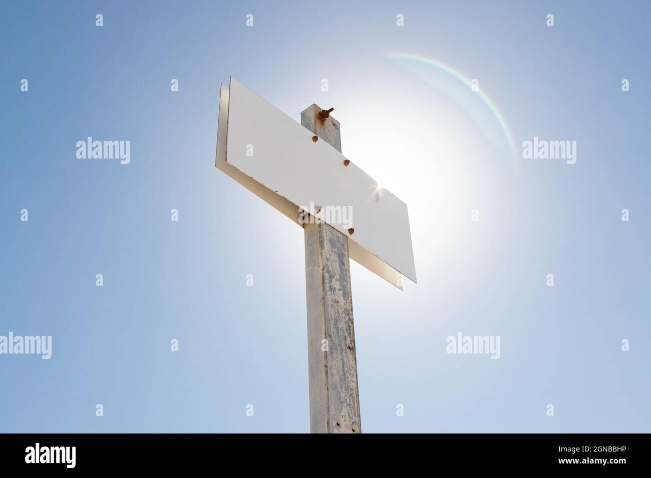 Blank sign against blue sky Stock Photo - Alamy