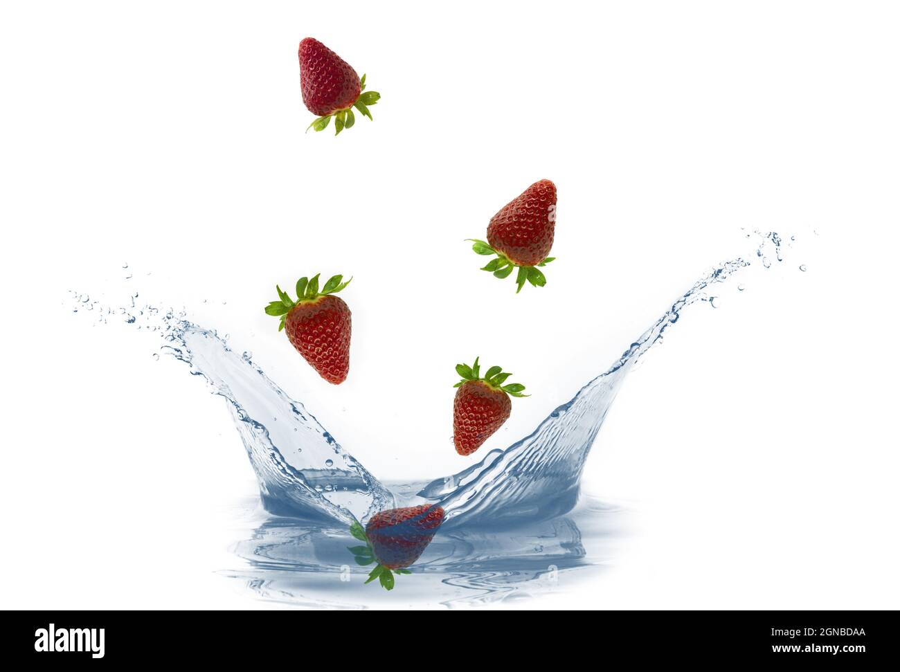 Strawberries falling into the water with splashes of water Stock Photo ...