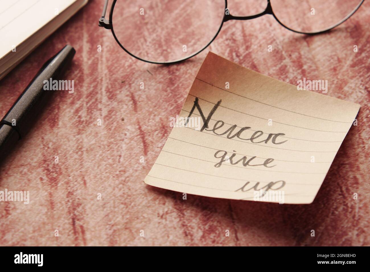 never give up word on stick note on table Stock Photo - Alamy