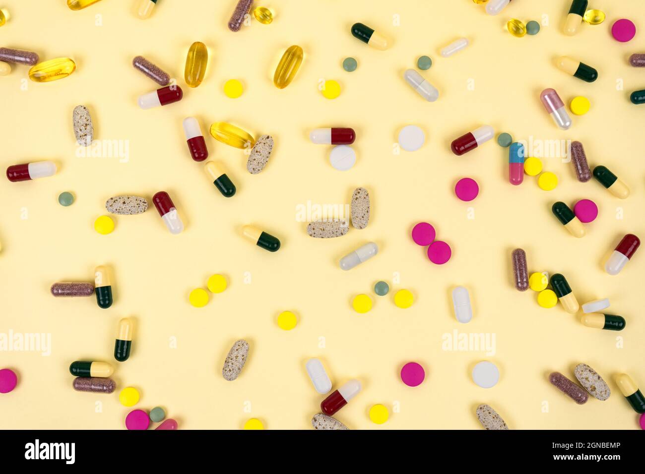 Background from multi-colored pills and capsules. Beige background ...