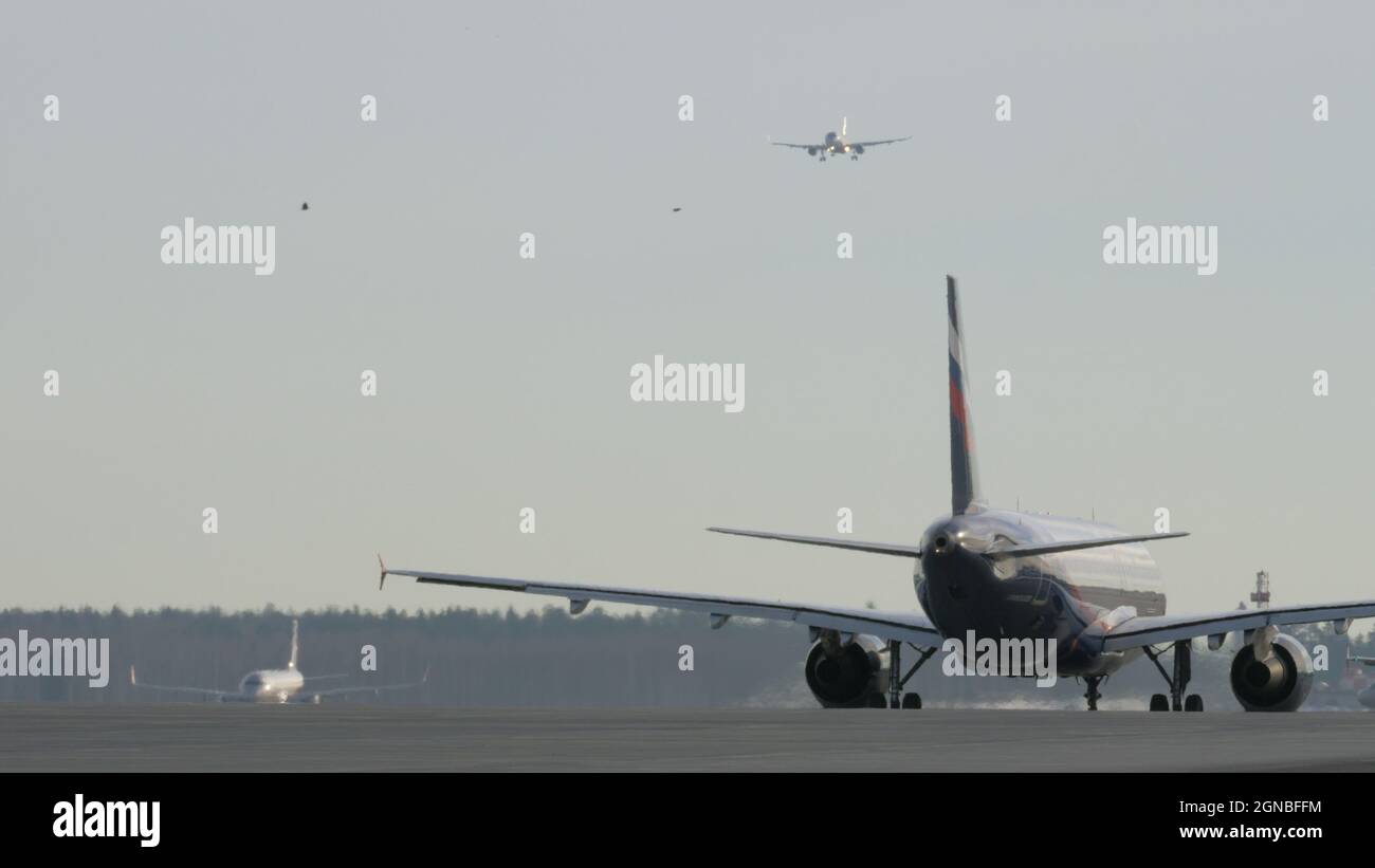 Planes preparing to take off and landing Stock Photo - Alamy