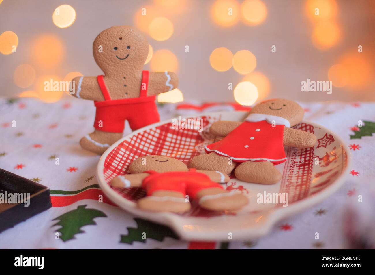 Smiling gingerbread man with lights in background Stock Photo - Alamy