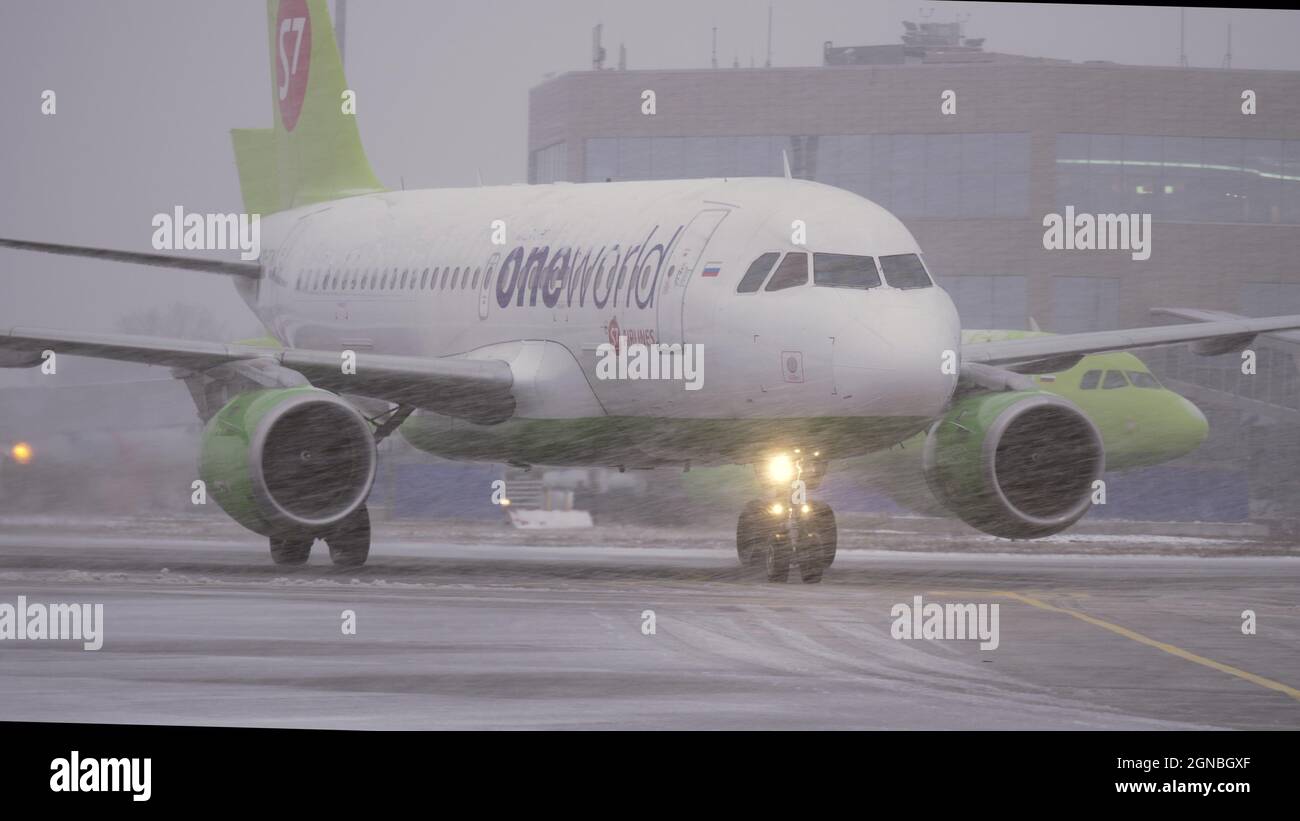 Airplane driving at the airport during blizzard, Moscow Stock Photo - Alamy