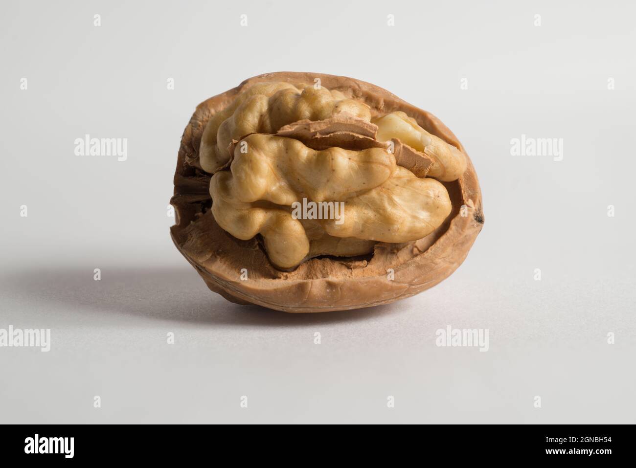 split walnut on a light background Stock Photo - Alamy