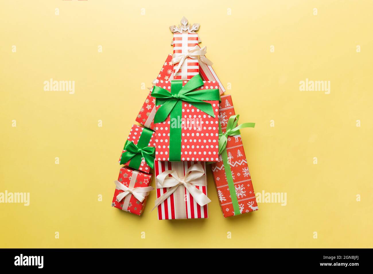 Christmas tree made of beautifuly wrapped presents on colored ...