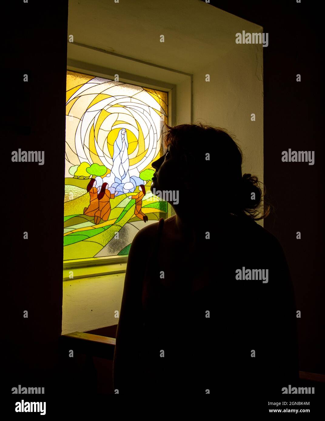 Shadow, silhouette of person, behind colorful window, church, religious ...