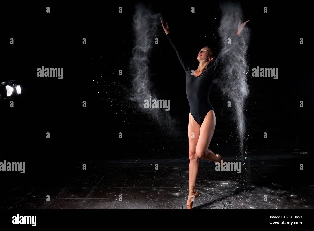 Artistic dance pose using powder or dust. Beautiful slim fit caucasian ...