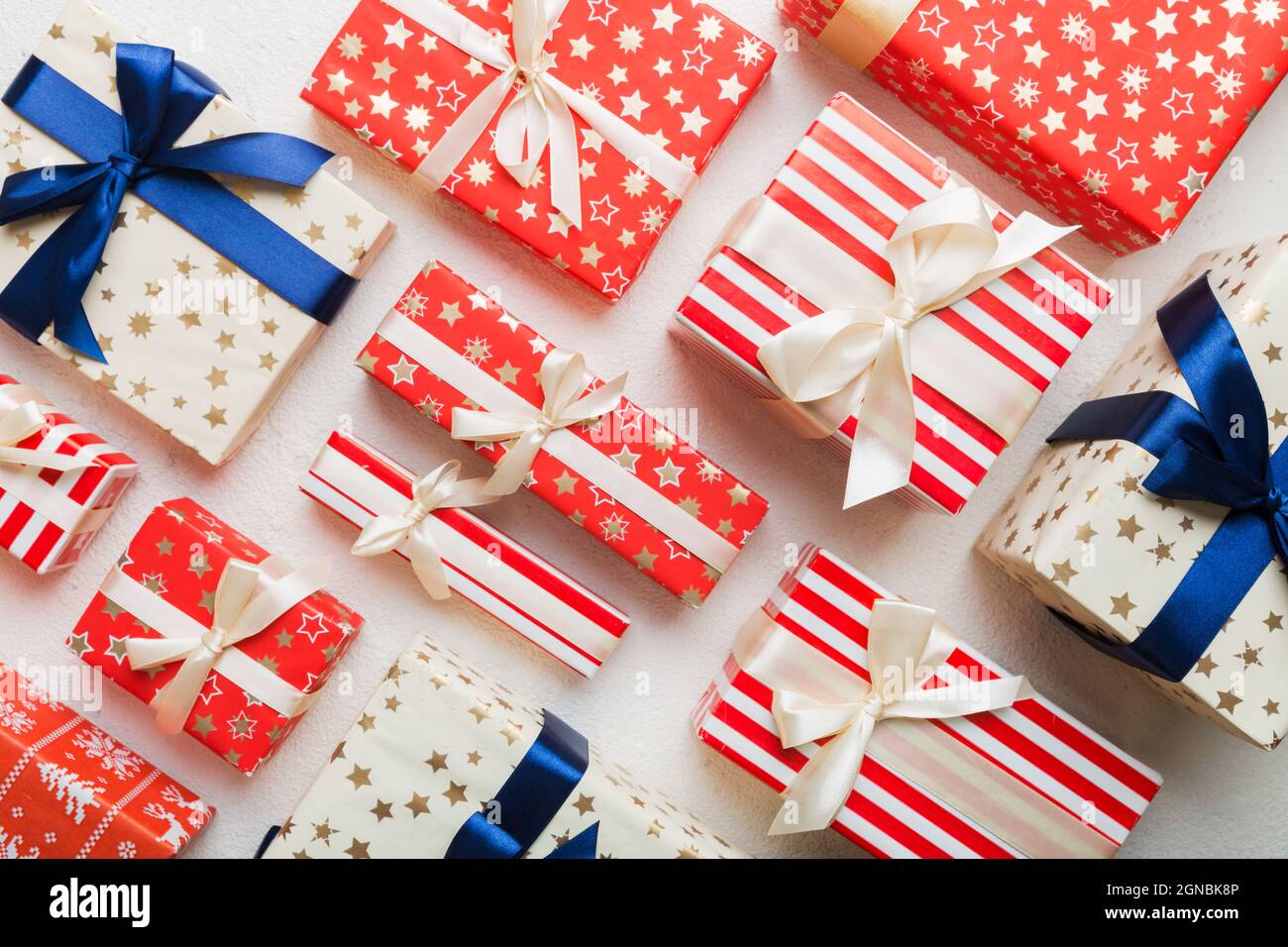 A lot of Christmas gift boxes in colored paper decorated on table, Top ...