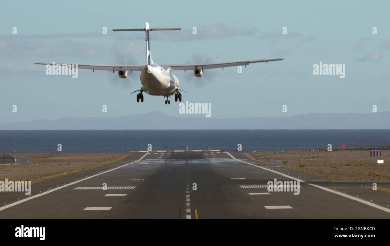 Jetliner landing on runway by the sea Stock Photo - Alamy