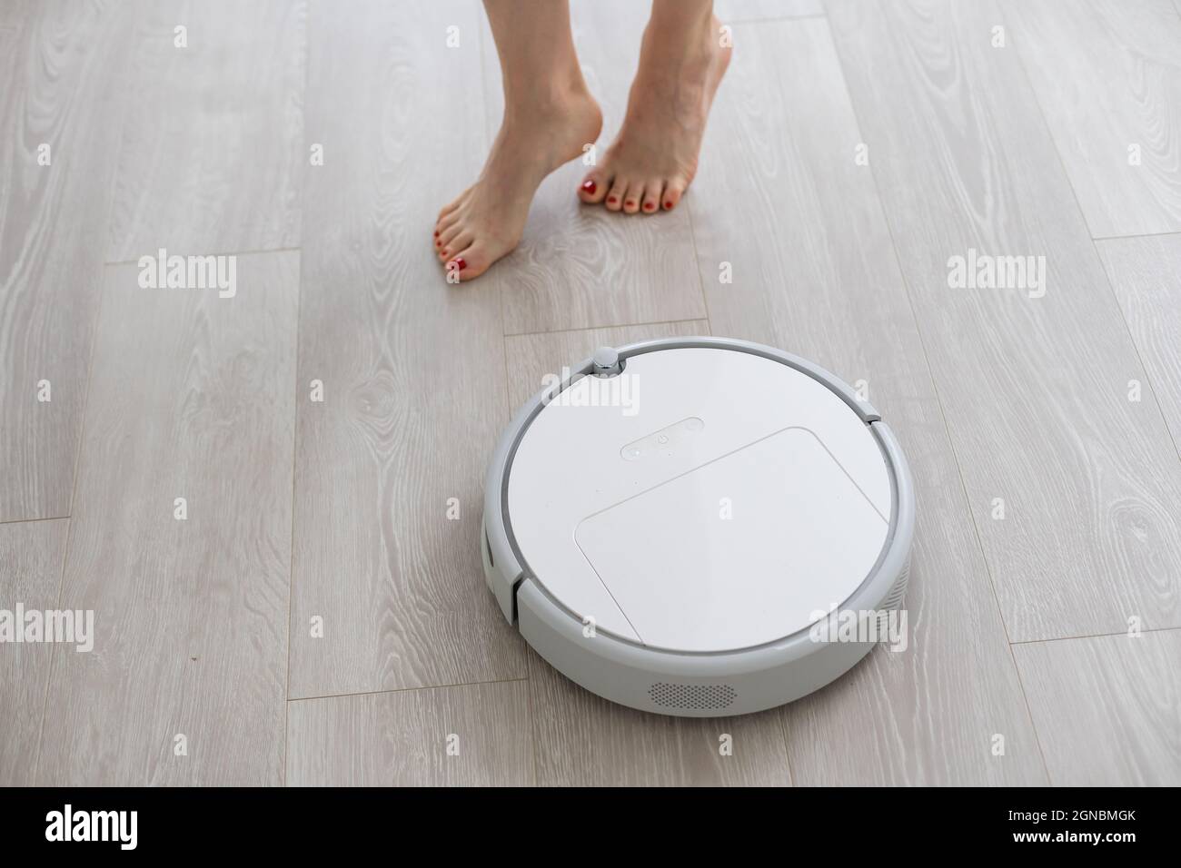 Human leg using smart robotic technology vacuum cleaner cleaning floor ...