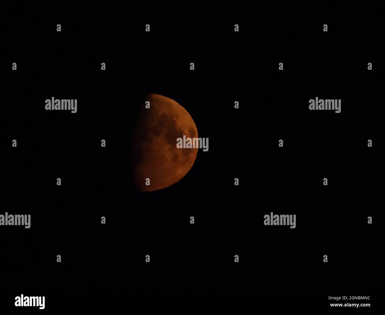 Half of red moon in the night sky Stock Photo - Alamy