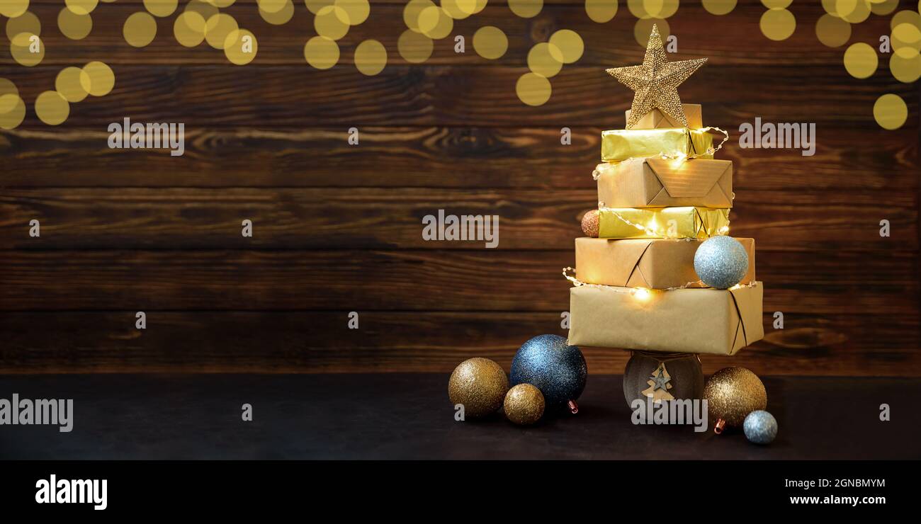 Christmas tree made from gift boxes with decorations against brown ...