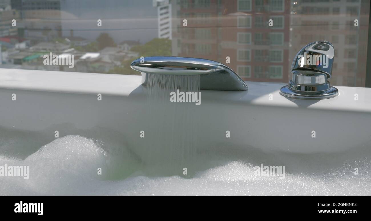 Woman running bath with foam Stock Photo - Alamy