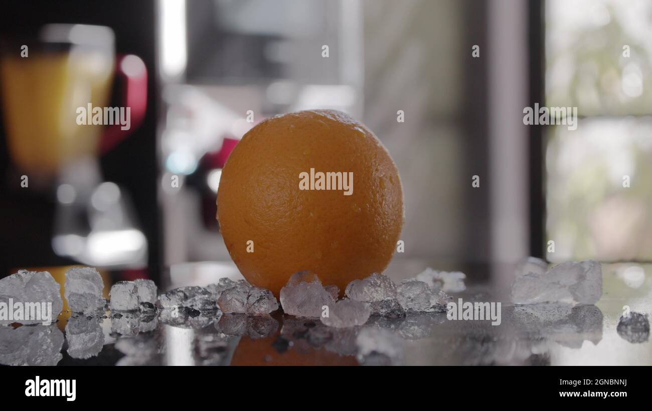 An orange in ice Stock Photo - Alamy
