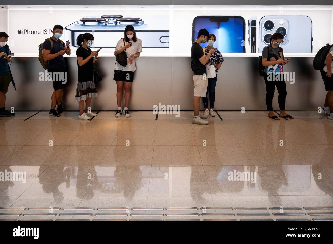Hong Kong, China. 24th Sep, 2021. Shoppers queue at an Apple store ...