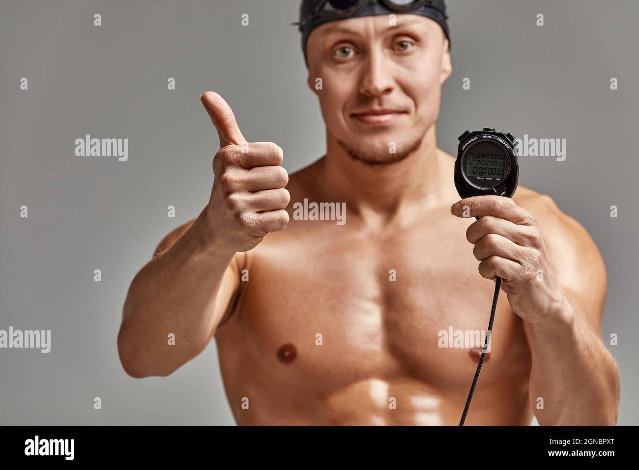 A coach with a stopwatch in his hands, a sports swimming coach with a ...