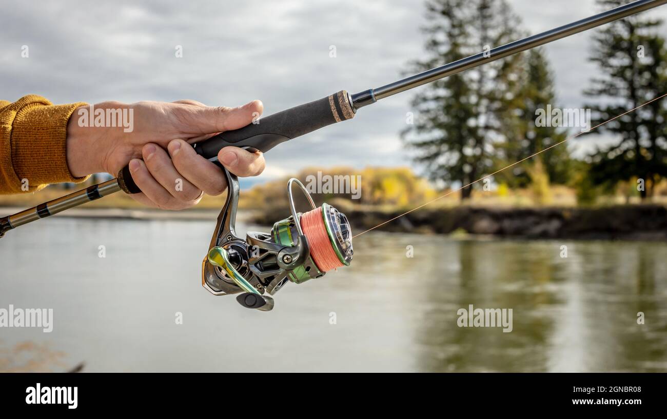 Male hands of a fisherman are holding a spinning closeup. Concept of ...